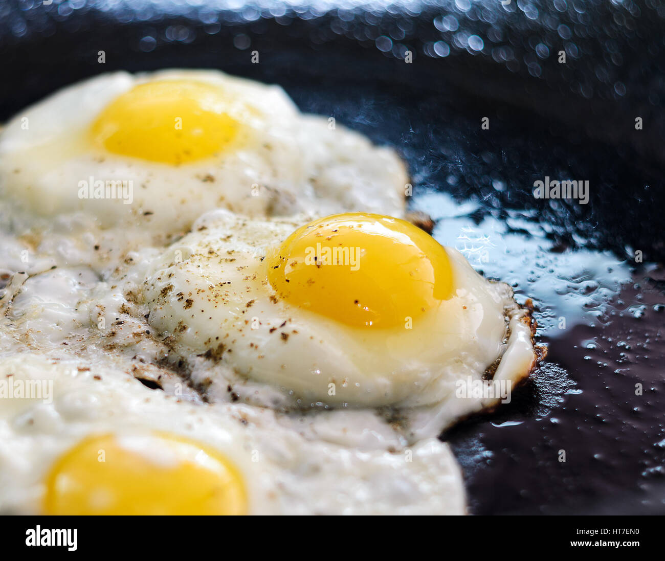 Fried eggs in a frying pan. Process of cooking eggs closeup. Food ...
