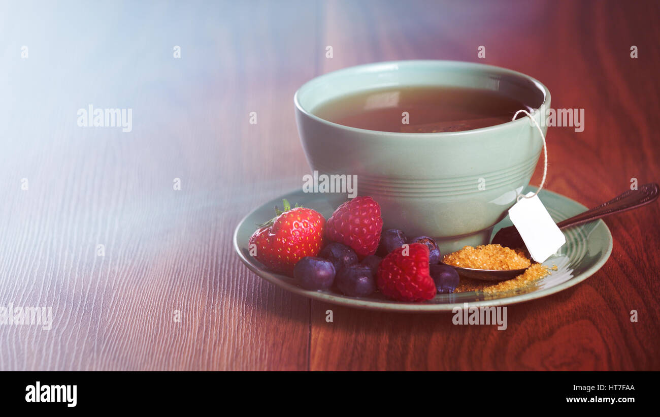 Cup of fruit tea with strawberries, raspberries and blueberries on ...