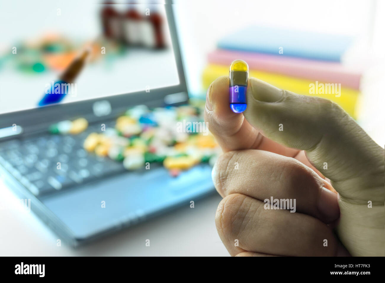 human hand is griping a capsule over medical research laboratory ...