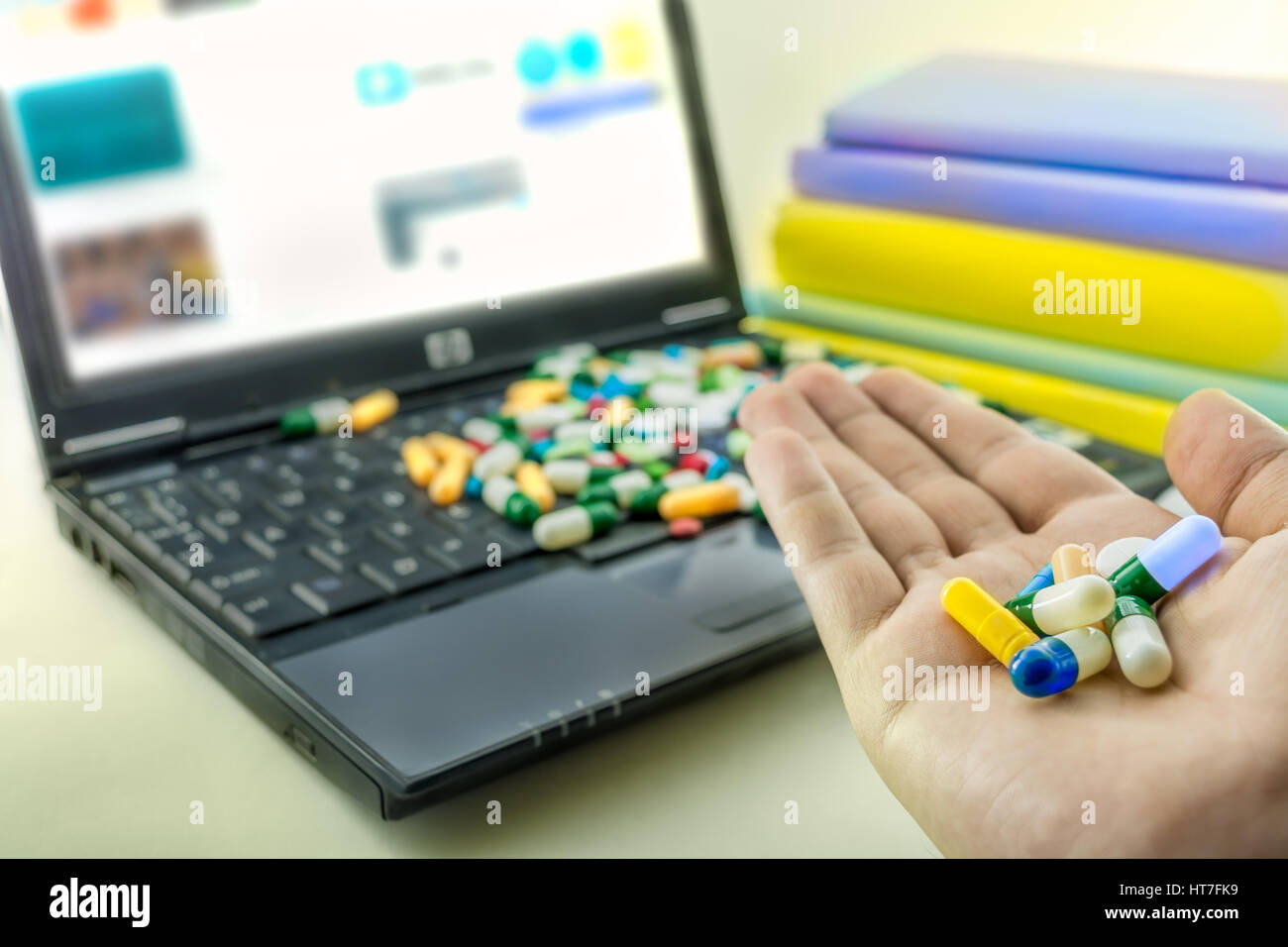 human hand holding colorful capsules over colorful laboratory ...