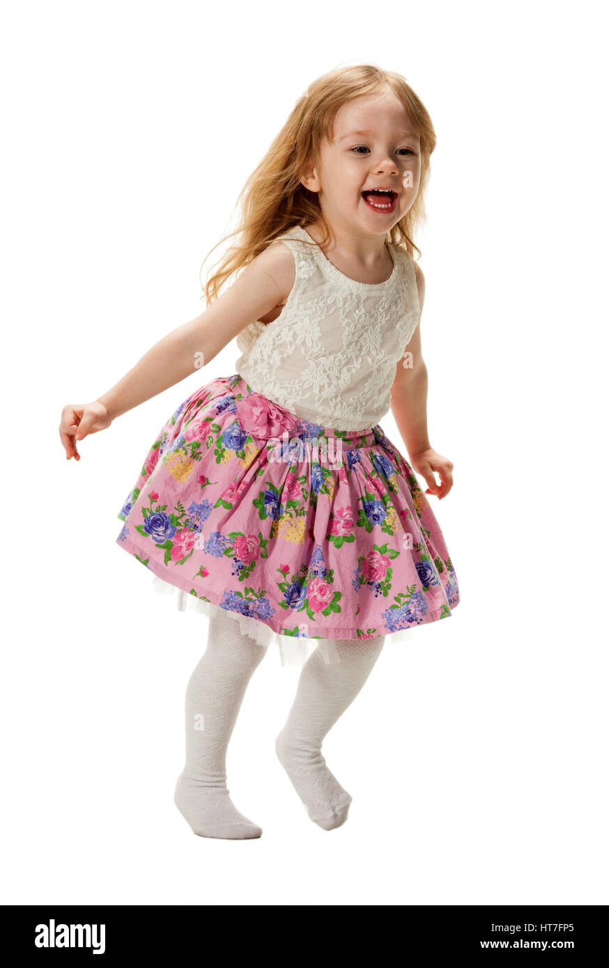 Cute three-year girl is jumping, running, dancing, laughing. Her hair ...