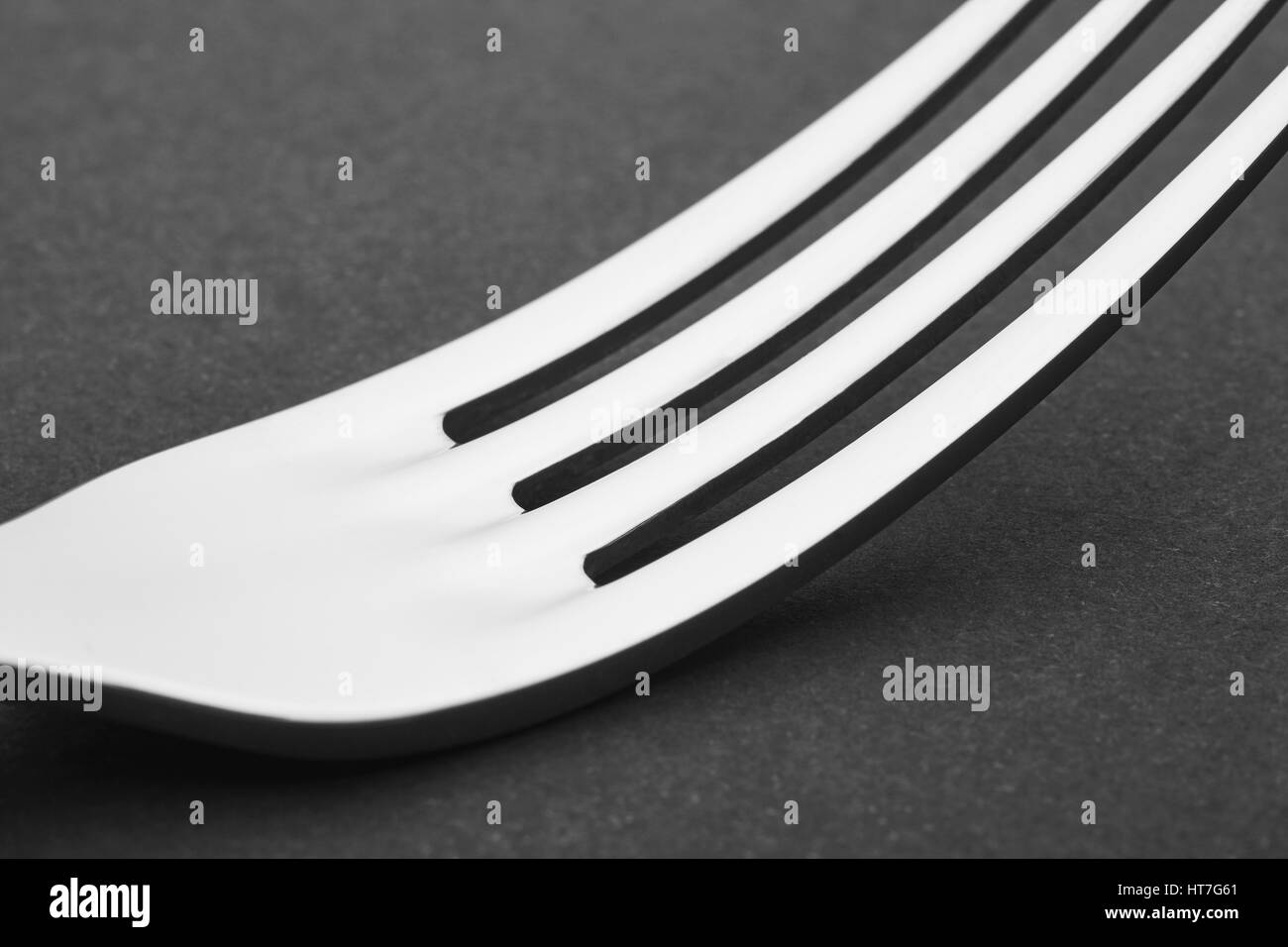 Fork detail over a black background. Cutlery. Vertical Stock Photo - Alamy