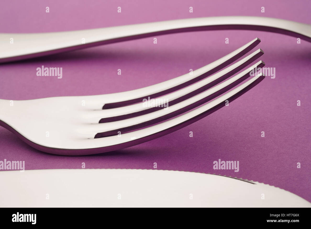 Knife fork and spoon detail over a purple background. Cutlery ...