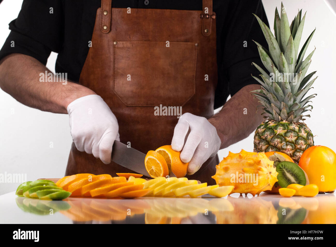 COmposition of sliced tropical exitic fruits on a white background ...