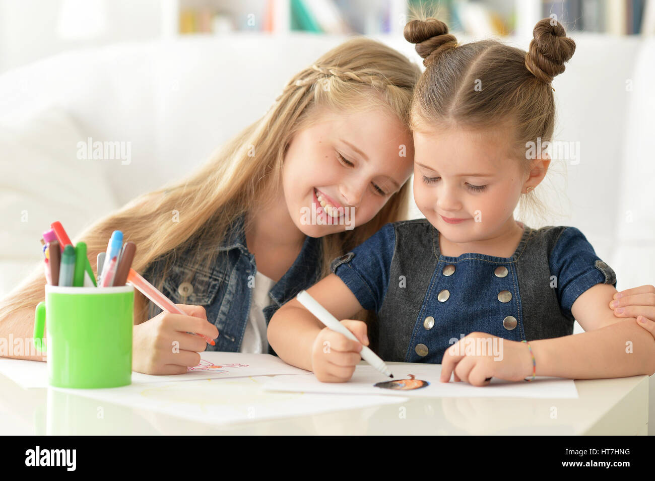Sisters drawing with pencils Stock Photo - Alamy