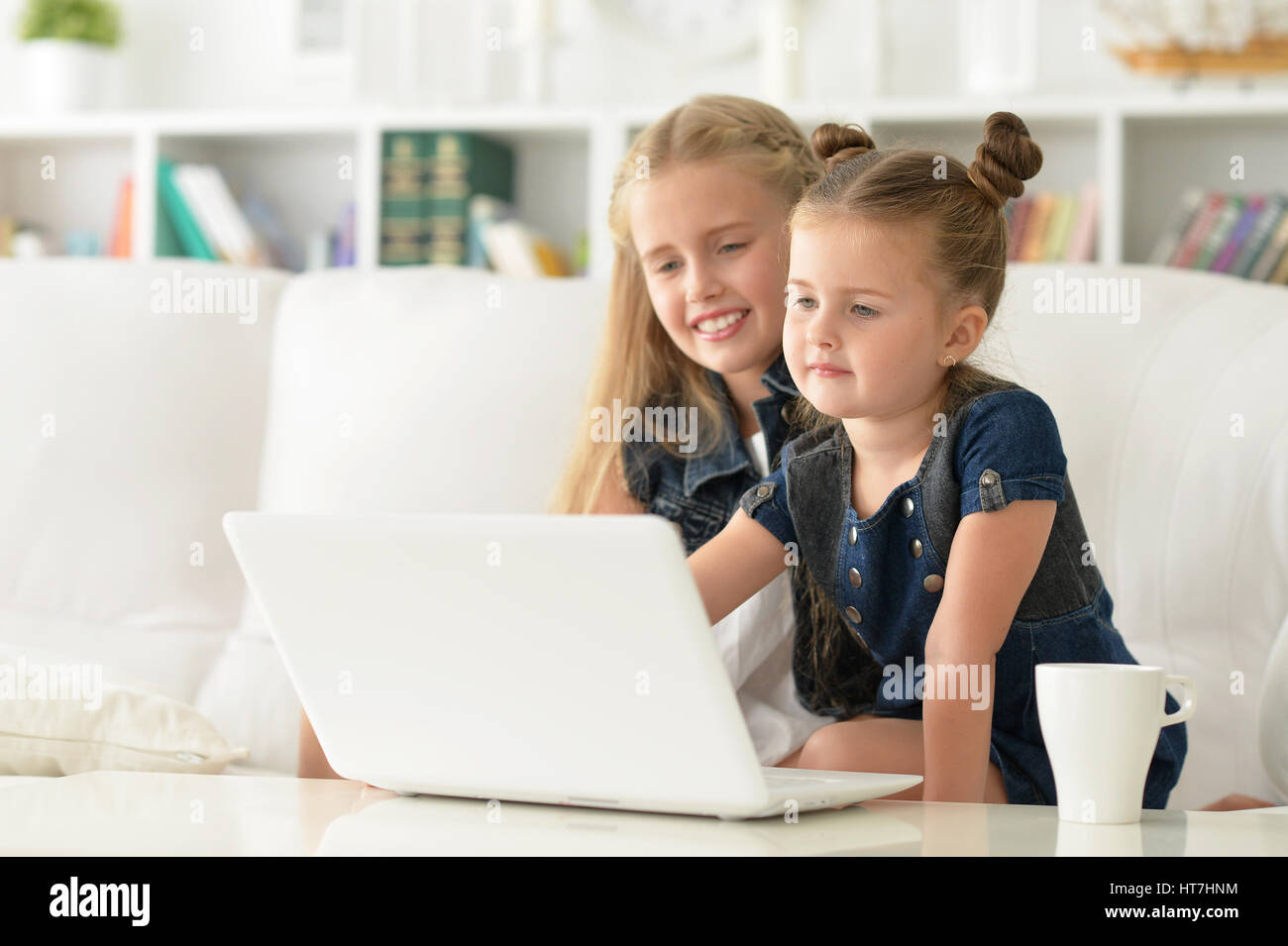 two sisters using laptop Stock Photo - Alamy