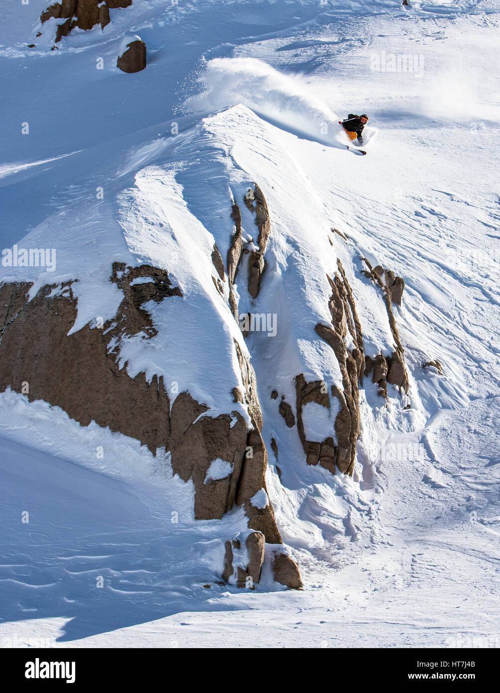 A Skier Makes A Powder Turn And Sprays Snow Into The Air On A Sunny Day ...