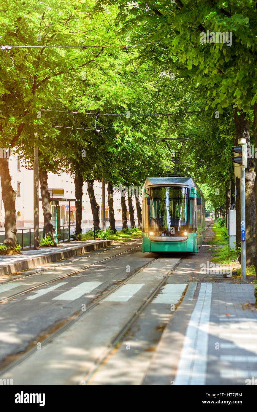 Modern green tram in Helsinki. City public high-tech electric vehicle ...