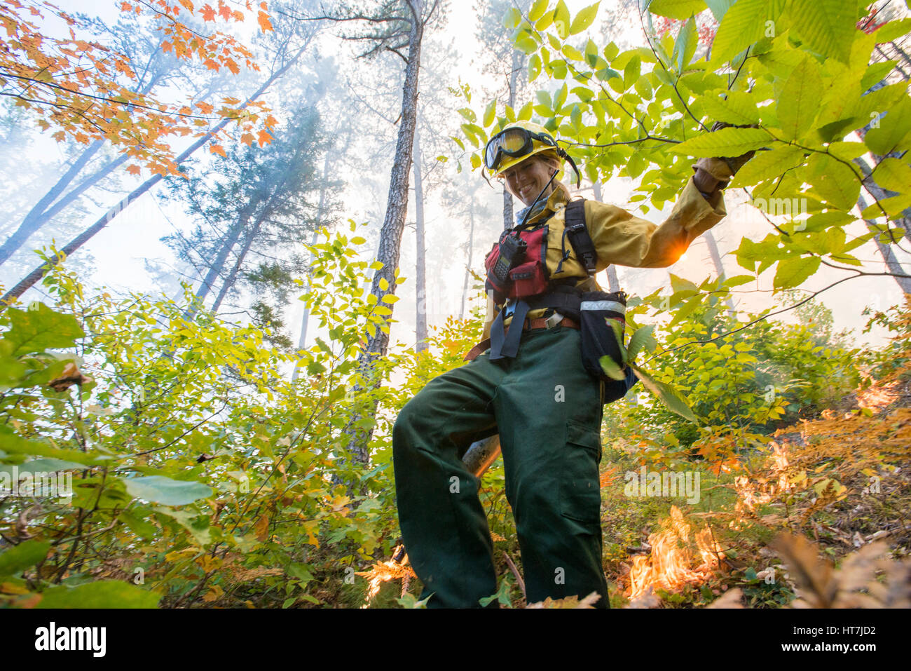 A Female Fire Fighter Igniting A Line Of Fire Stock Photo - Alamy