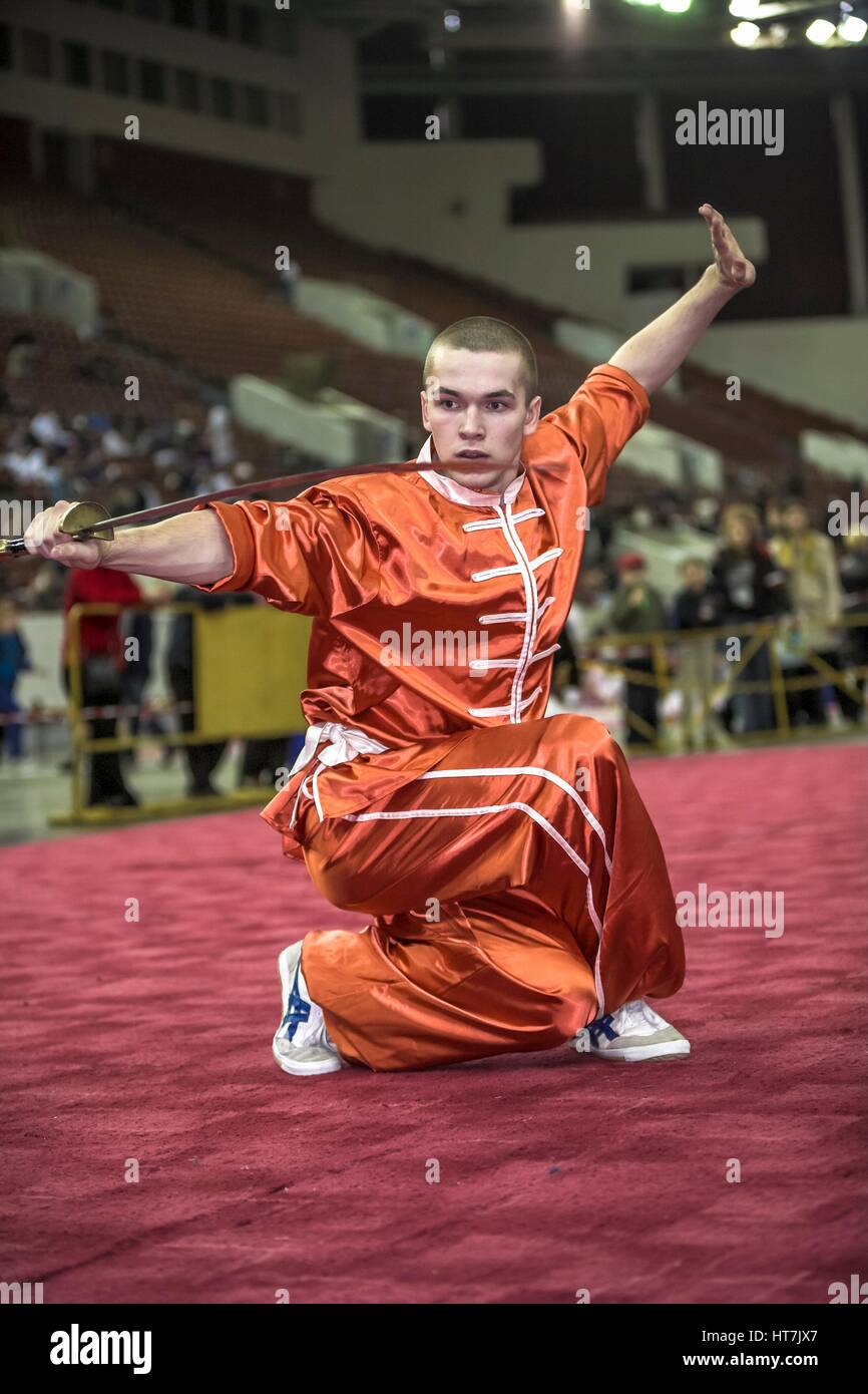 A Young Man With A Sword During A Wushu Performance Stock Photo - Alamy