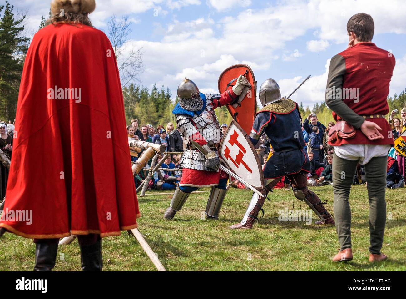Armed And Armored Men Fight With Swords And Shields At A Festival Of ...