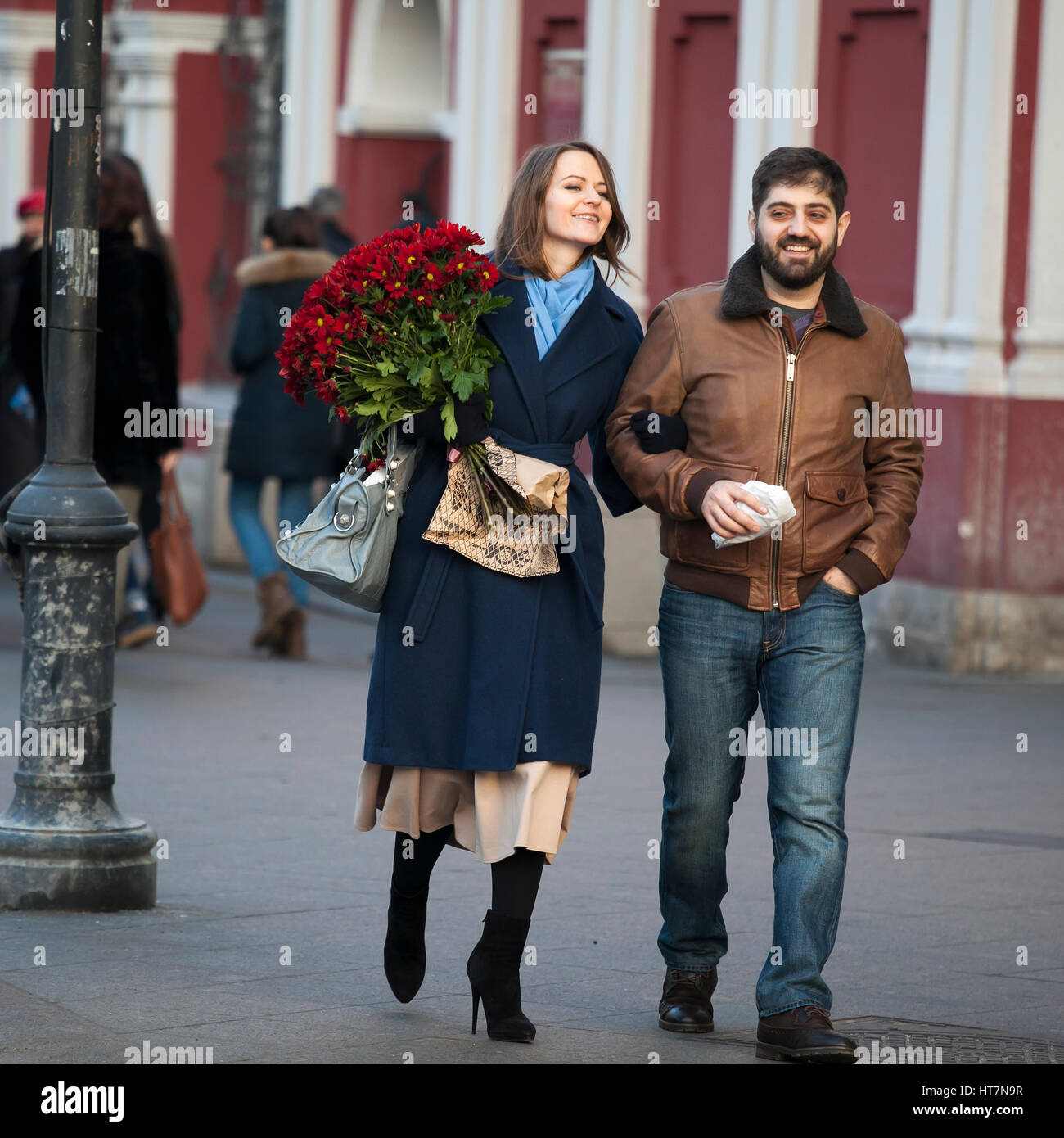 Moscow, Russia - March 8, 2016: Happy couple walking on the street ...
