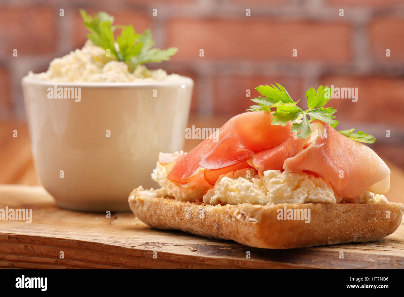 Sandwich with white cottage cheese and ham on wooden background Stock ...