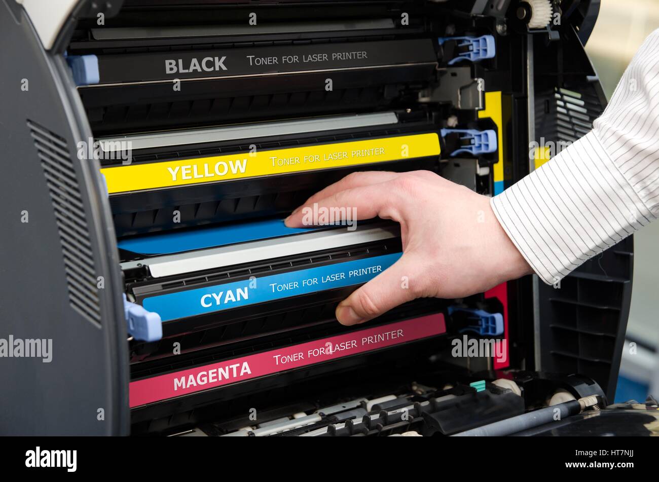 Man puts toner in the printer Stock Photo - Alamy