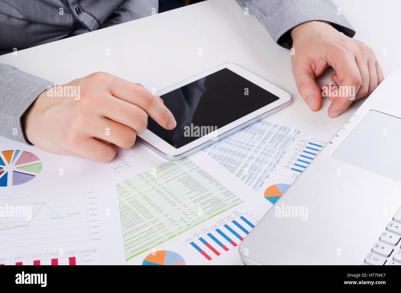 Businessman working with digital tablet. Report charts on desk Stock ...