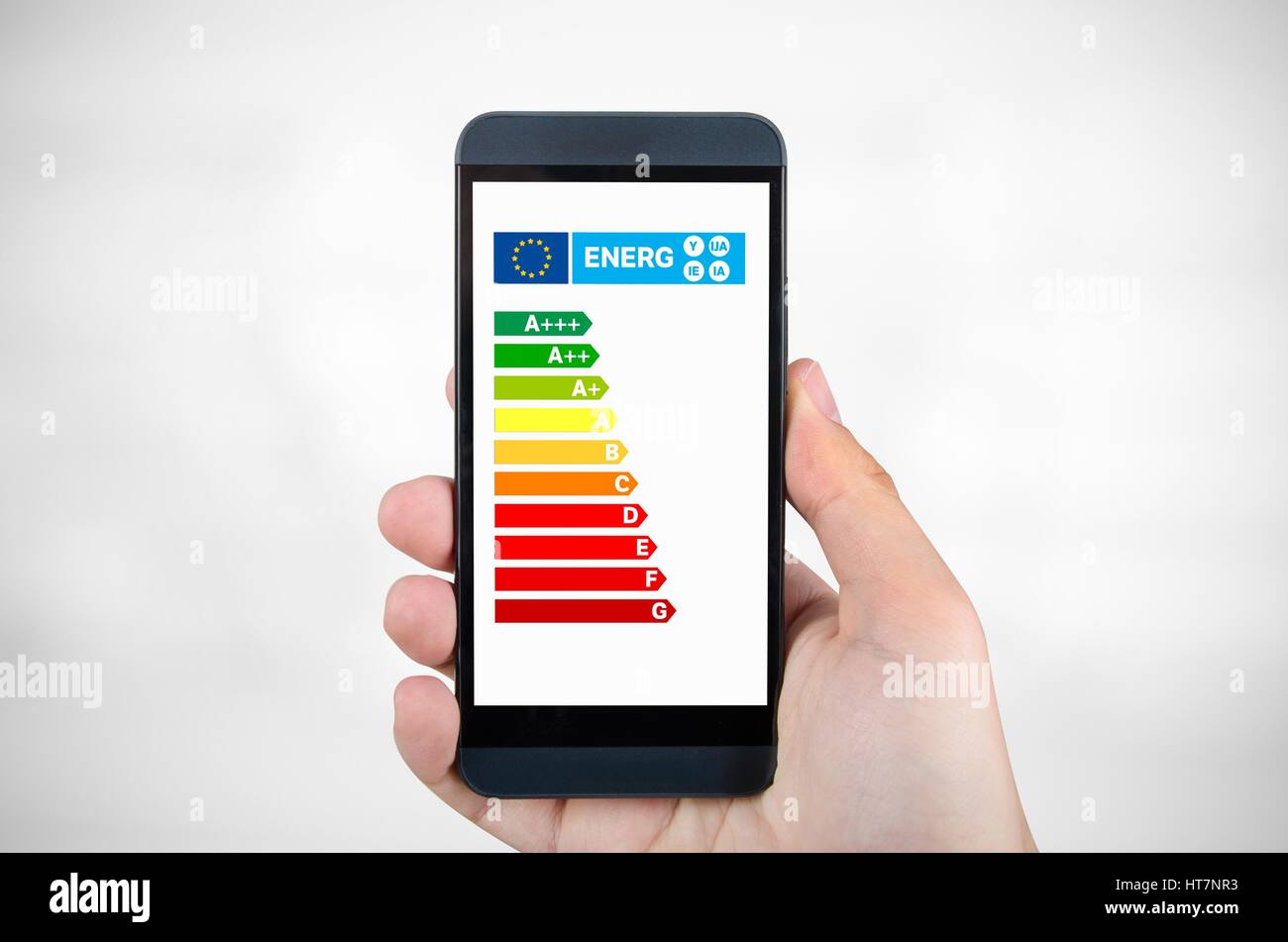 Man holding smartphone with energy efficiency chart. Savings in home ...