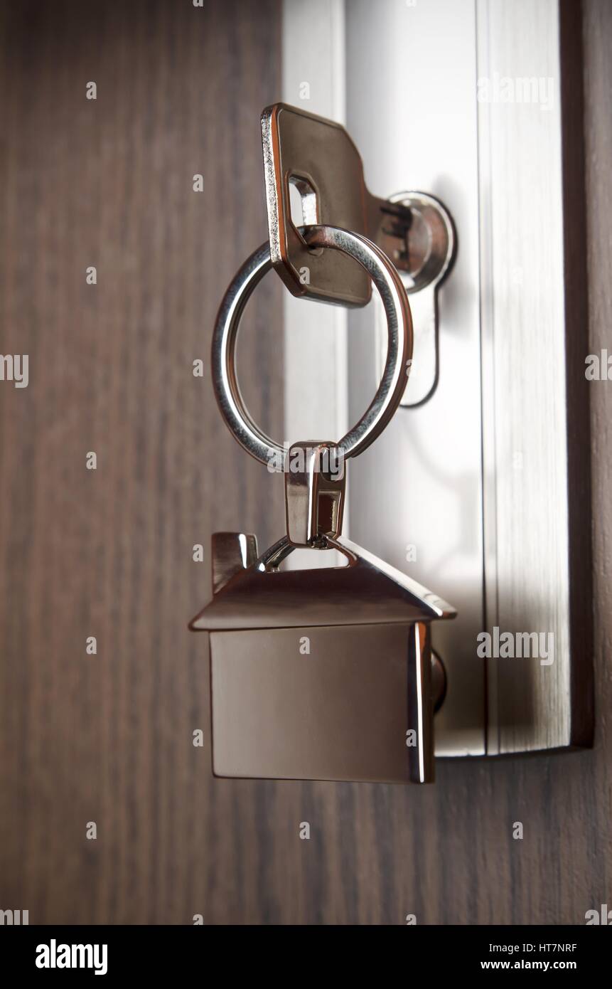 House key with silver chrome pendant with home shape Stock Photo - Alamy