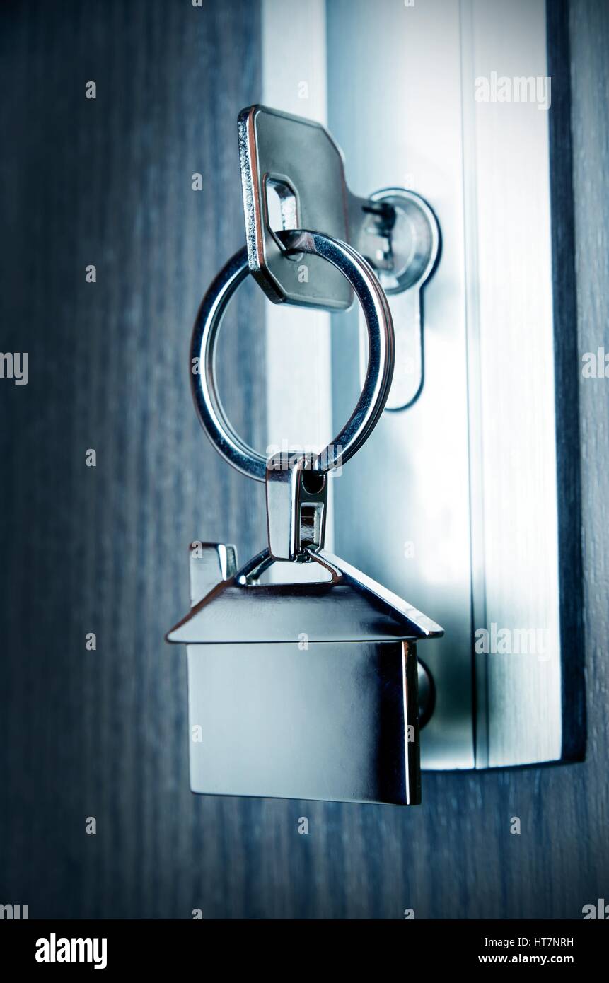 House key with silver chrome pendant with home shape Stock Photo - Alamy