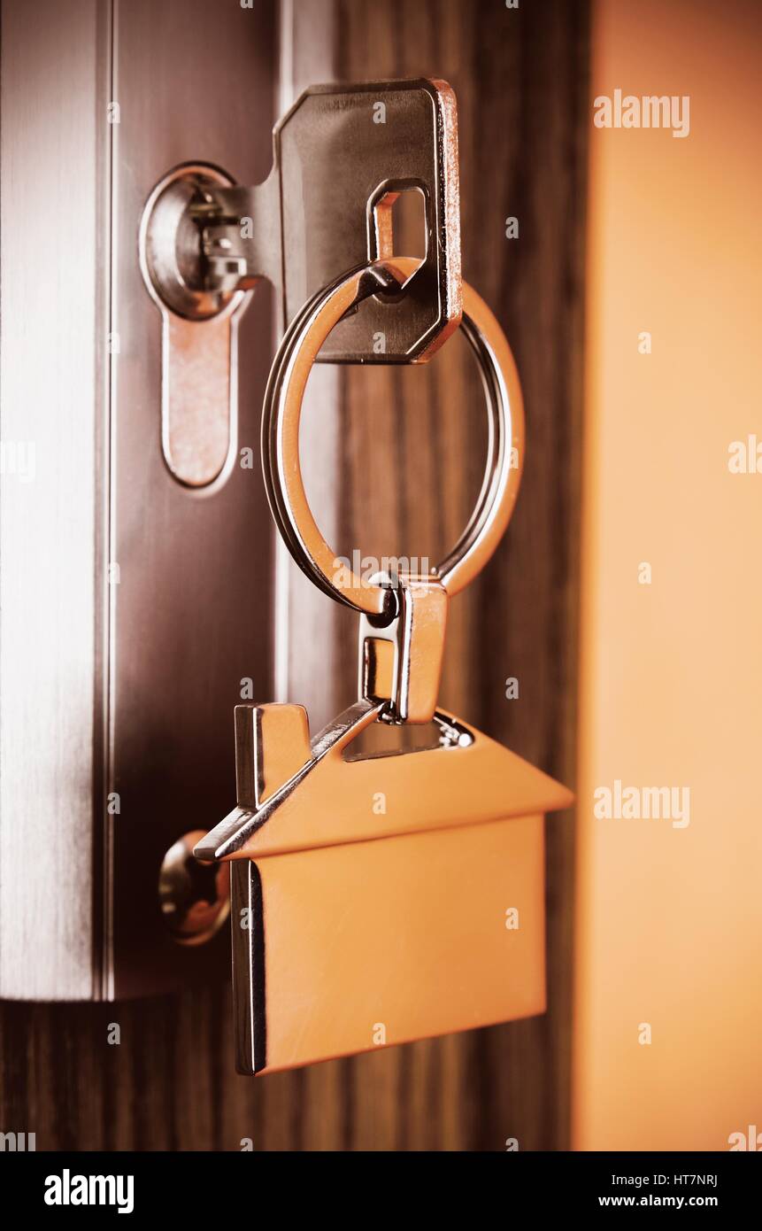 House key with silver chrome pendant with home shape Stock Photo - Alamy