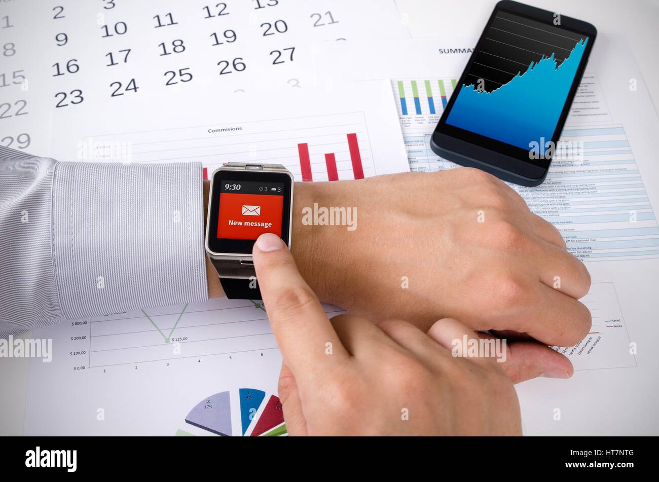 Man working with smart watch in office. New message received ...