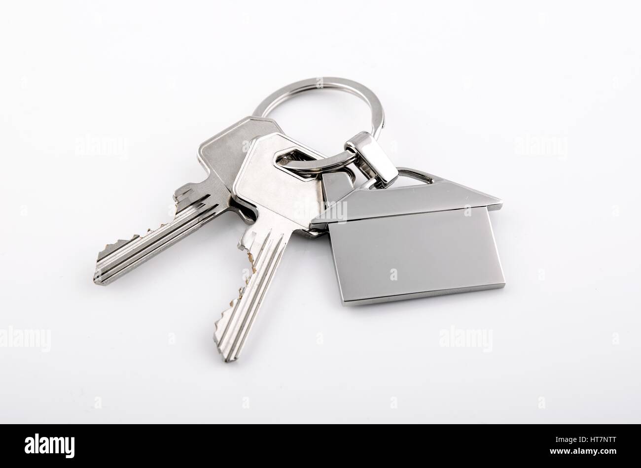 Keys and house chrome pendant with home shape isolated on white ...