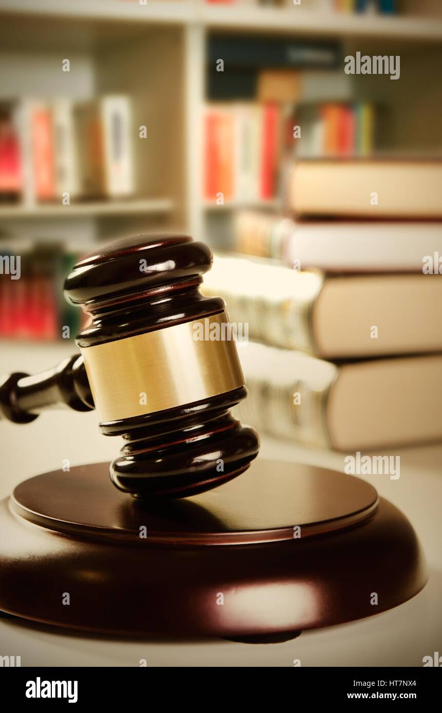 Close up of judge gavel in court. Library with lot of books in ...