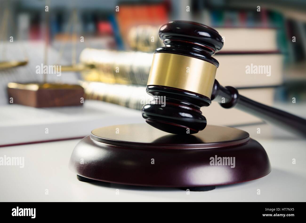 Judge gavel and scale in court. Library with lot of books in background ...