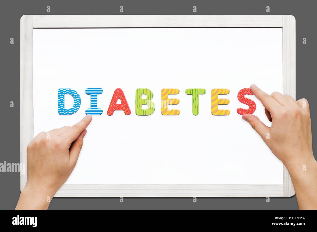 Hands put the word Diabetes with magnetic letters. Colorful alphabet ...