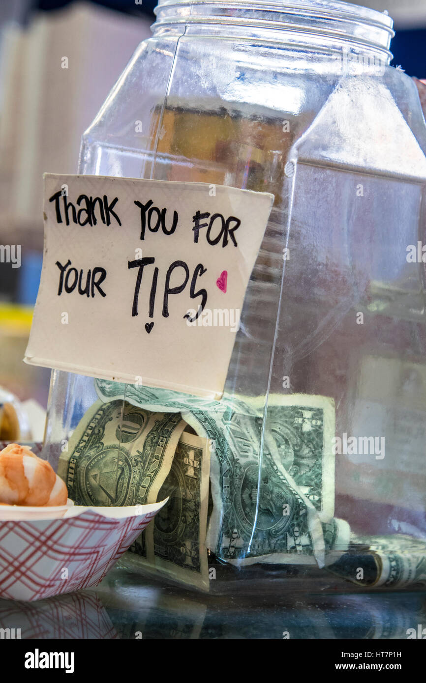 Tips Jar containing dollar bills at takeaway seafood stall Fisherman's ...