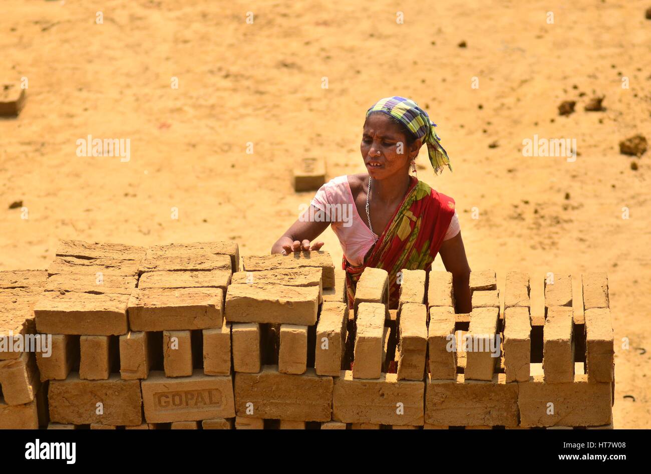 Dimapur, India. 08th Mar, 2017. An Indian woman labour works at a ...