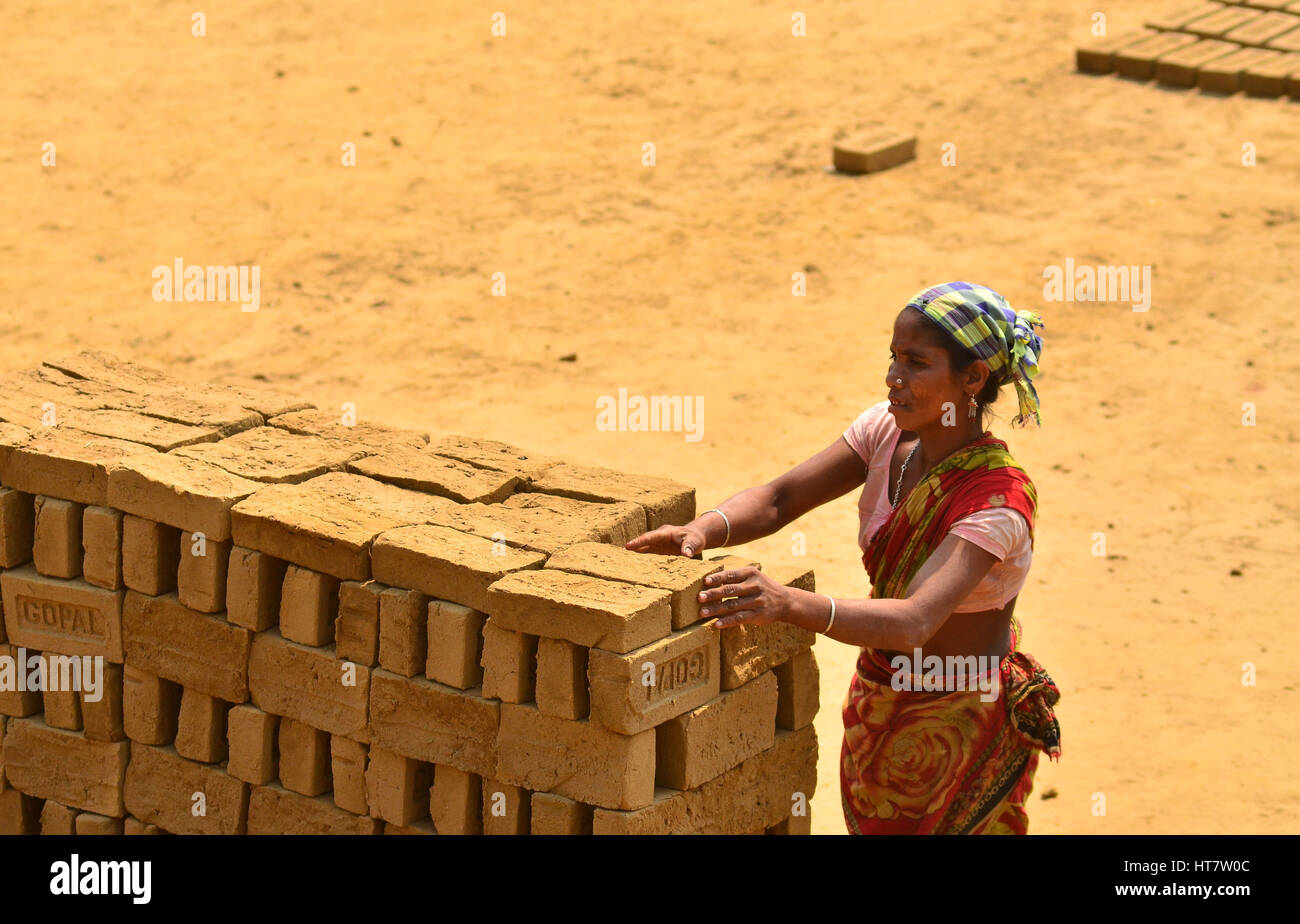 Dimapur, India. 08th Mar, 2017. An Indian woman labour works at a ...