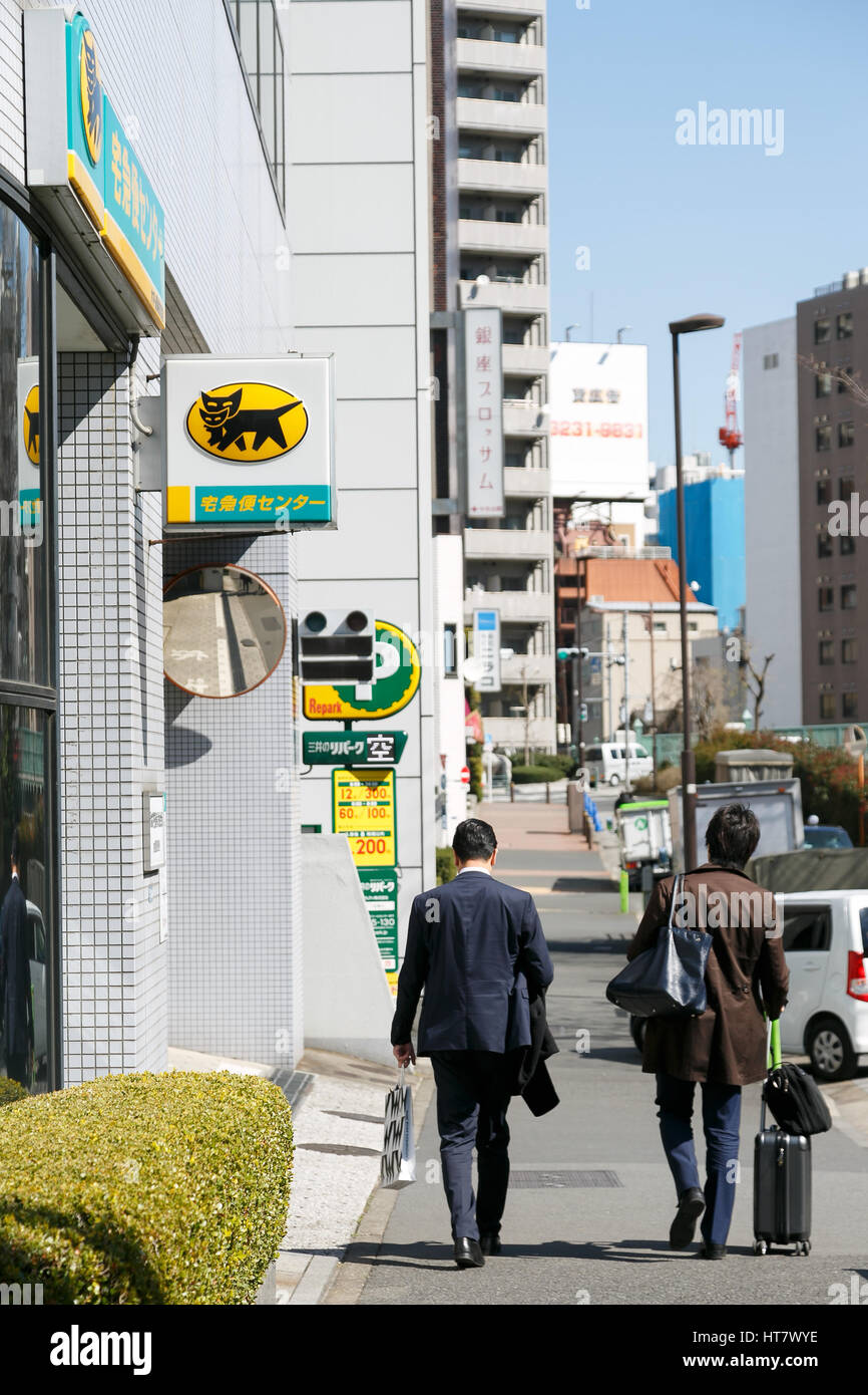 Tokyo, JapanPedestrians walk past the Yamato Holdings logo on March 8 ...