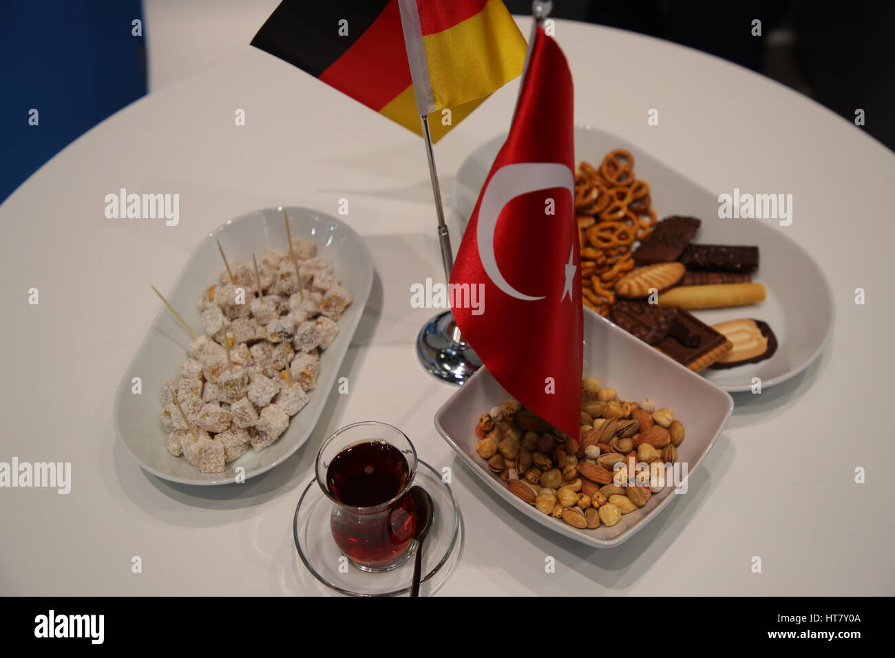 Berlin, Germany. 08th Mar, 2017. A German and a Turkish flag and food ...