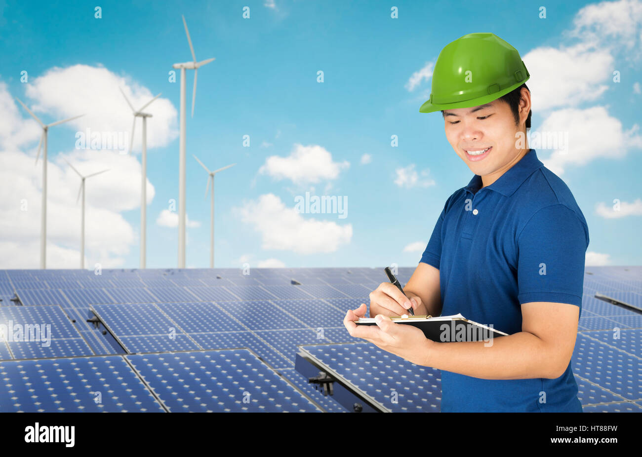 solar panel technician with solar panel and wind turbines Stock Photo ...