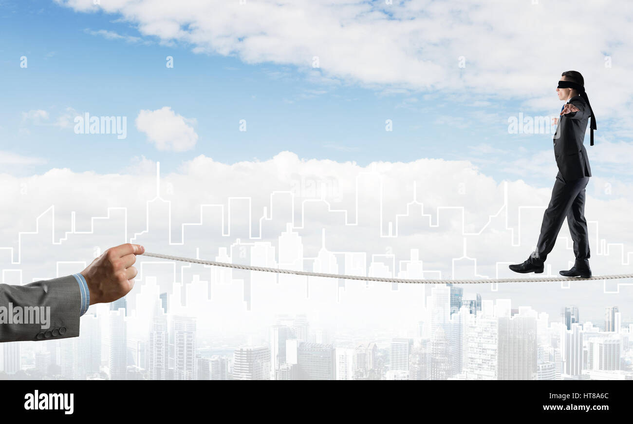 Business concept of risk support and assistance with man balancing on ...