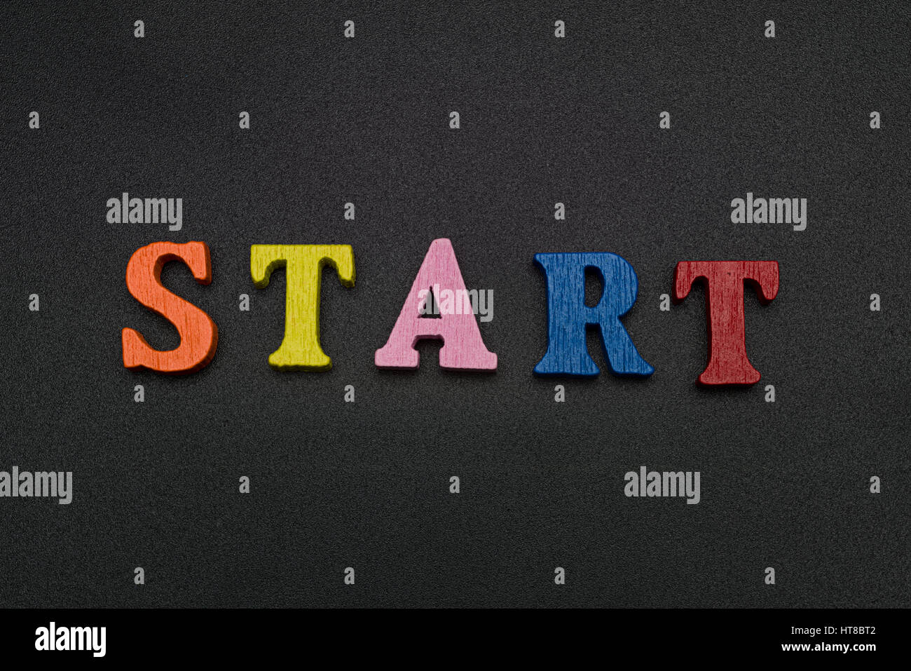 Start on a black background lined with letters Stock Photo - Alamy