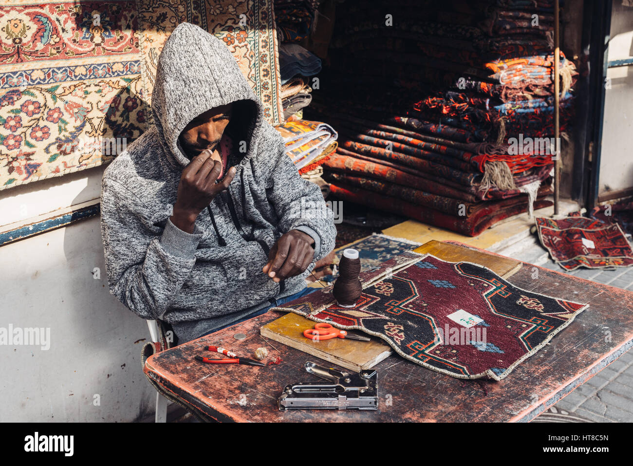 Man fixing a carpet, Jaffa, Israel Stock Photo - Alamy