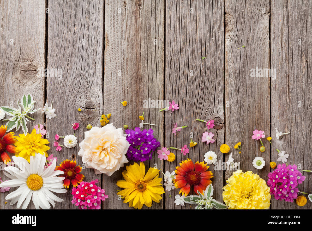 Garden flowers over wooden table background. Backdrop with copy space ...