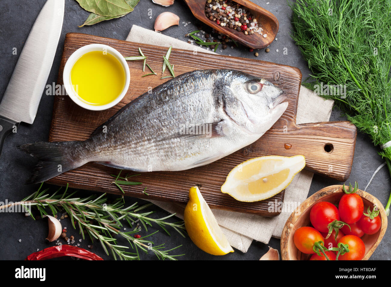 Raw fish cooking and ingredients. Dorado, lemon, herbs and spices. Top ...