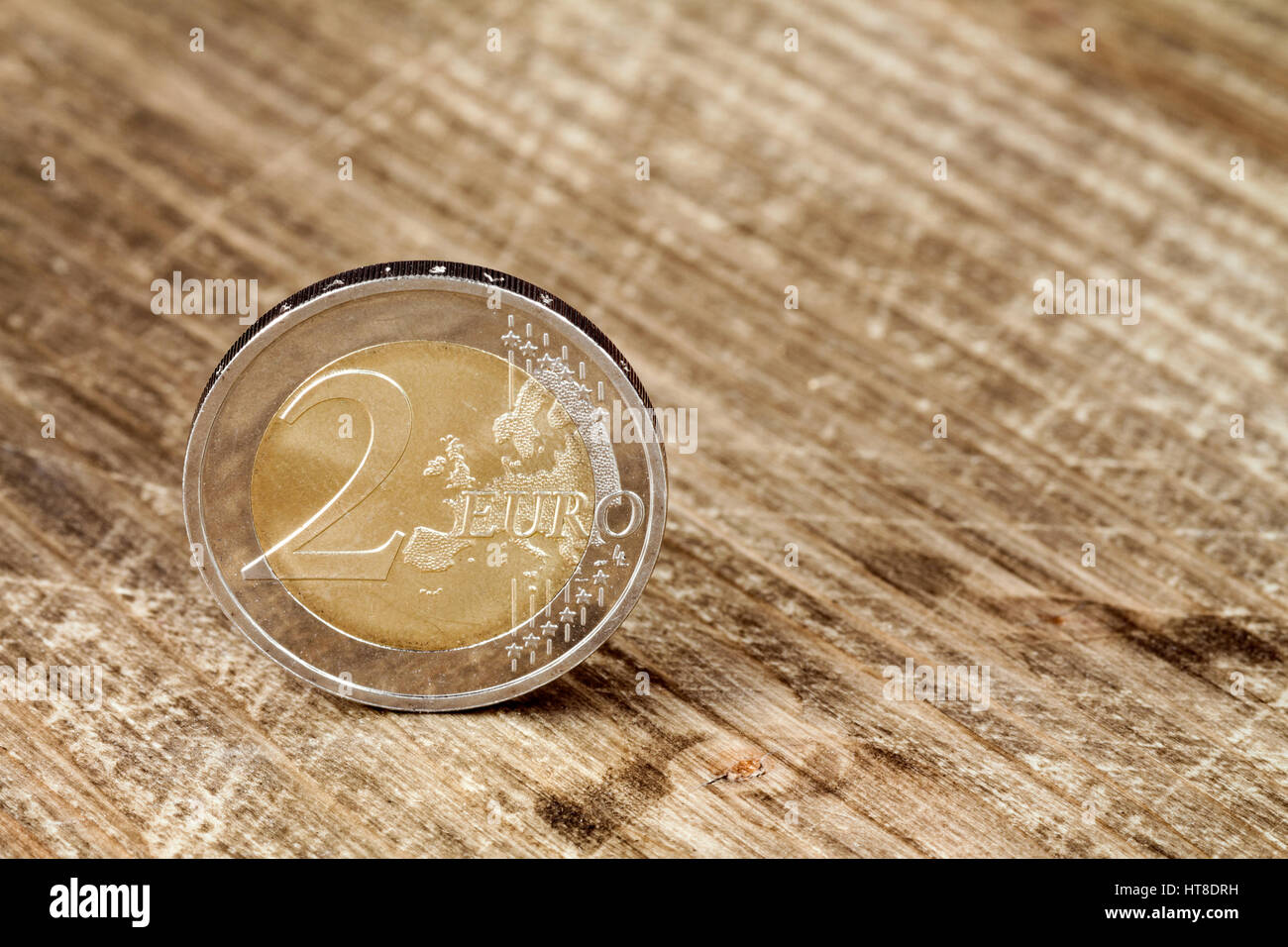 Two Euro coin on the wooden table surface Stock Photo - Alamy