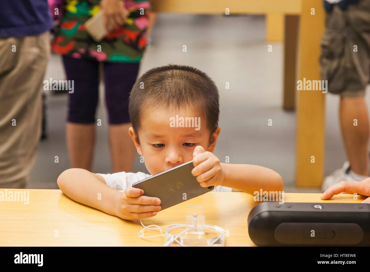 China, Hong Kong, Causeway Bay, Apple Store, Young Child Playing with ...