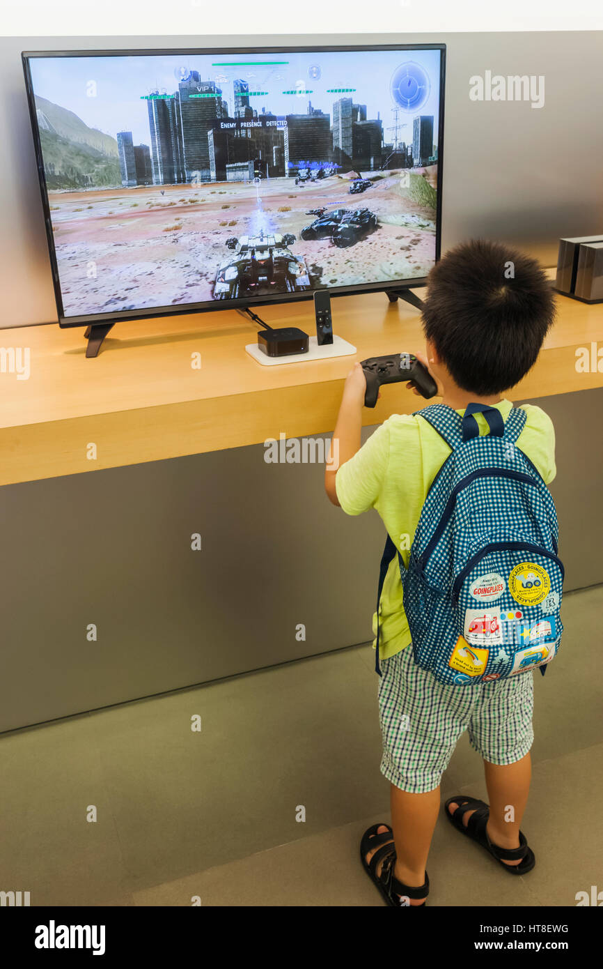 China, Hong Kong, Causeway Bay, Apple Store, Boy Playing on Games ...
