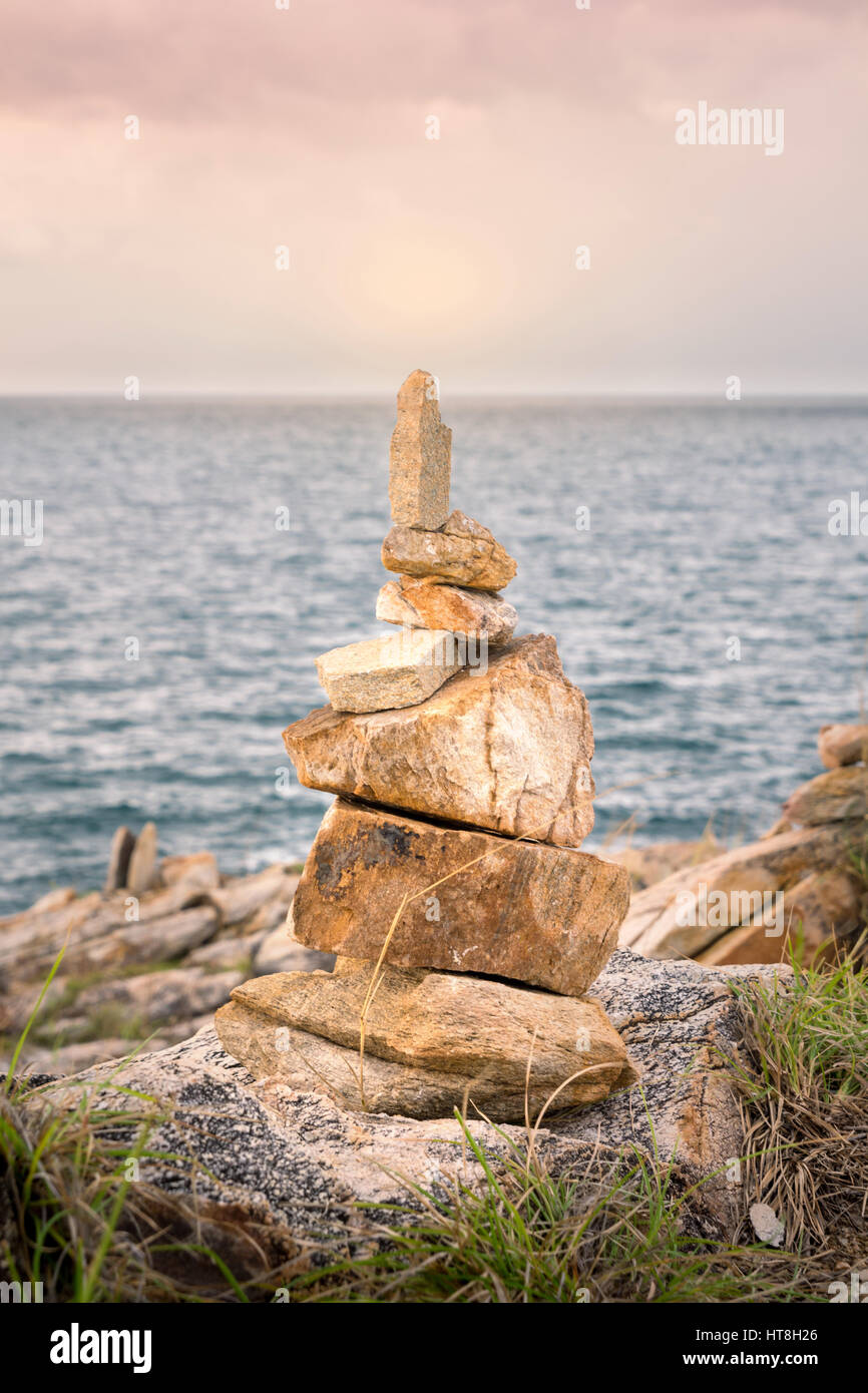 Stacked stones on a beach in Thailand at sunset Stock Photo - Alamy