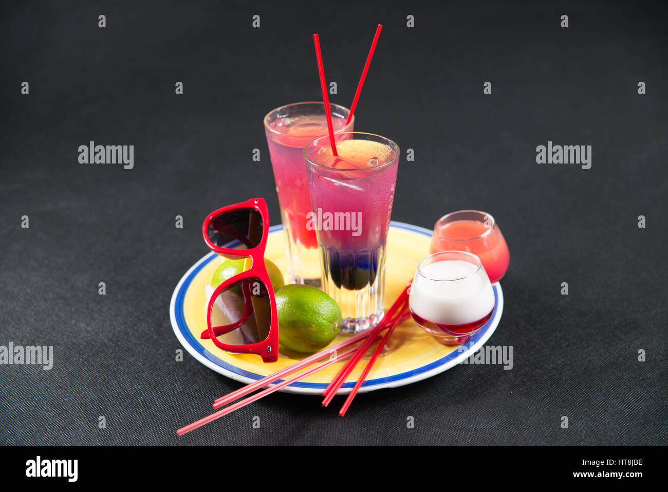 Two colored drinks, a combination of dark blue with purple, the second ...