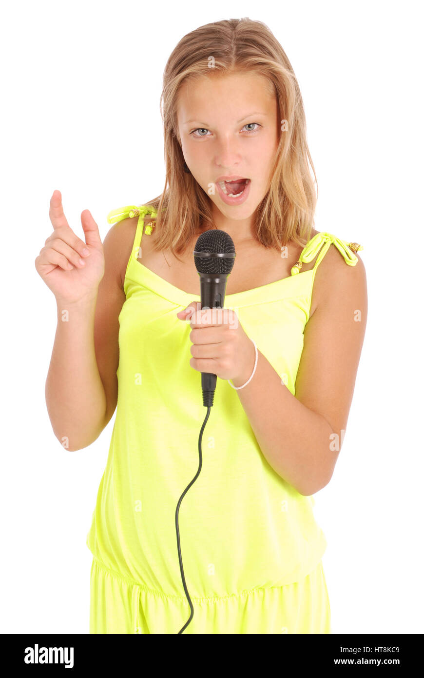 Beautiful teenage girl with microphone isolated on white background ...