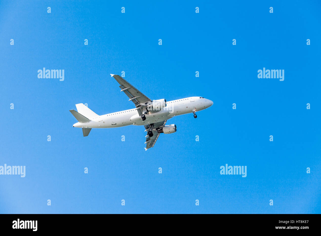 white airplane on a blue background. airplane in the sky Stock Photo ...