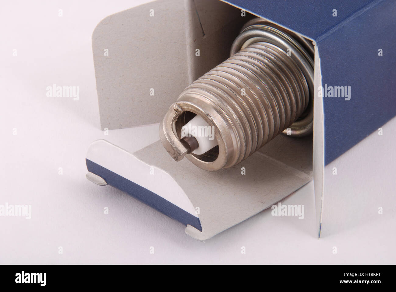 One new spark plugs in paper packaging on a gray background Stock Photo ...