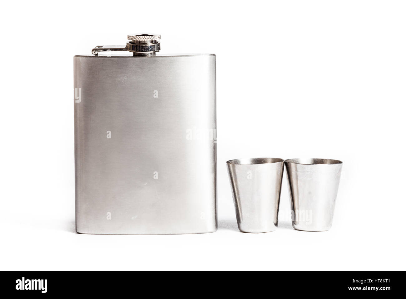 Hip flask and cups isolated on white Stock Photo - Alamy