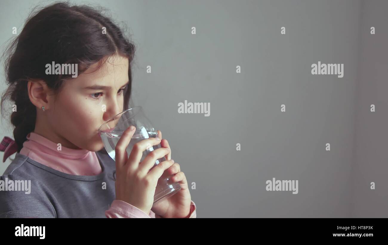 teen girl drinks water from glass cup the indoor Stock Photo - Alamy