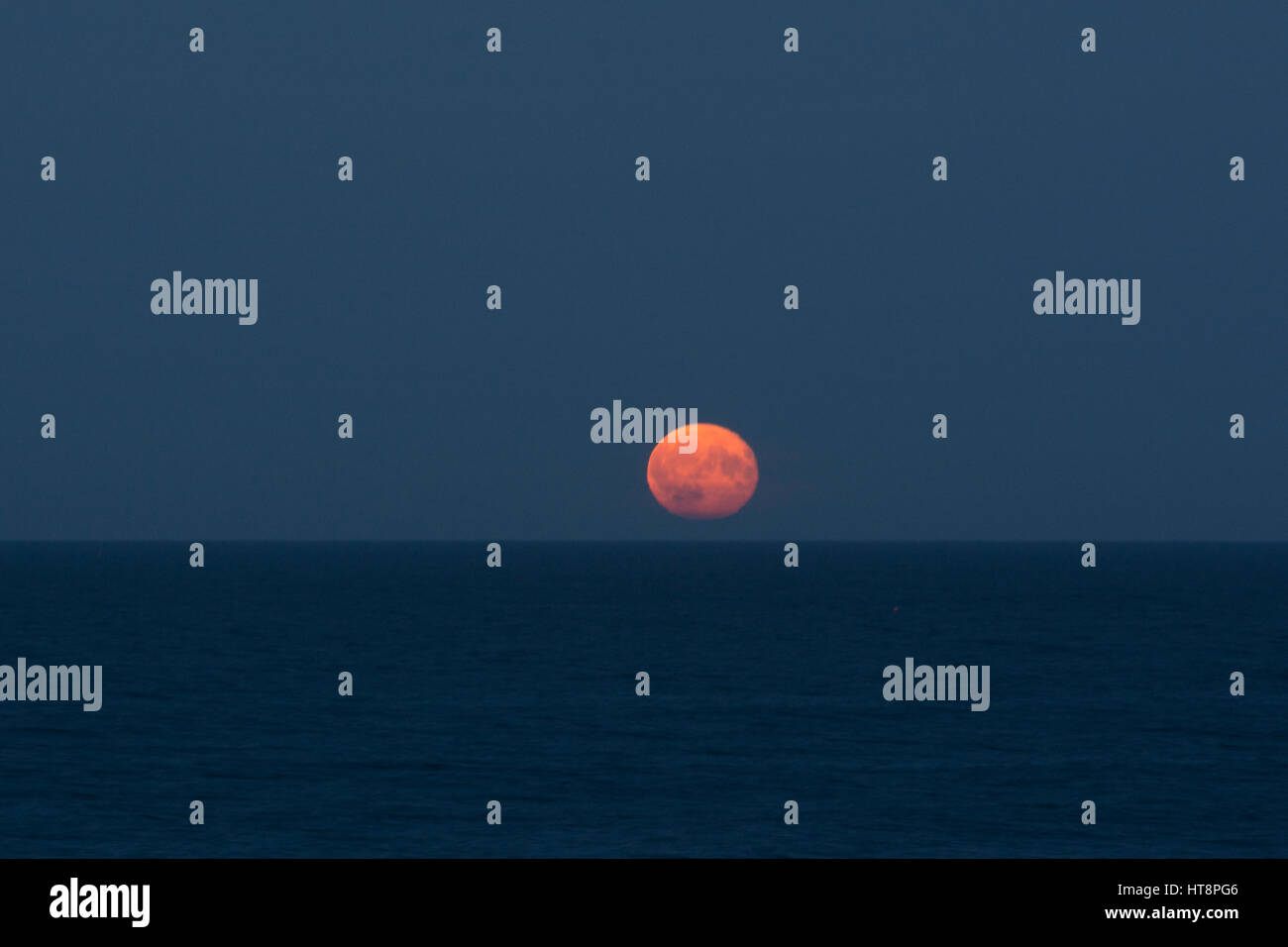 Full moon rising over the sea off the Northumberland coast Stock Photo ...